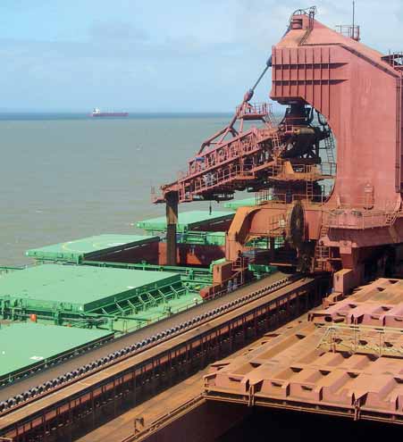 Self-unloading vessels and transloaders